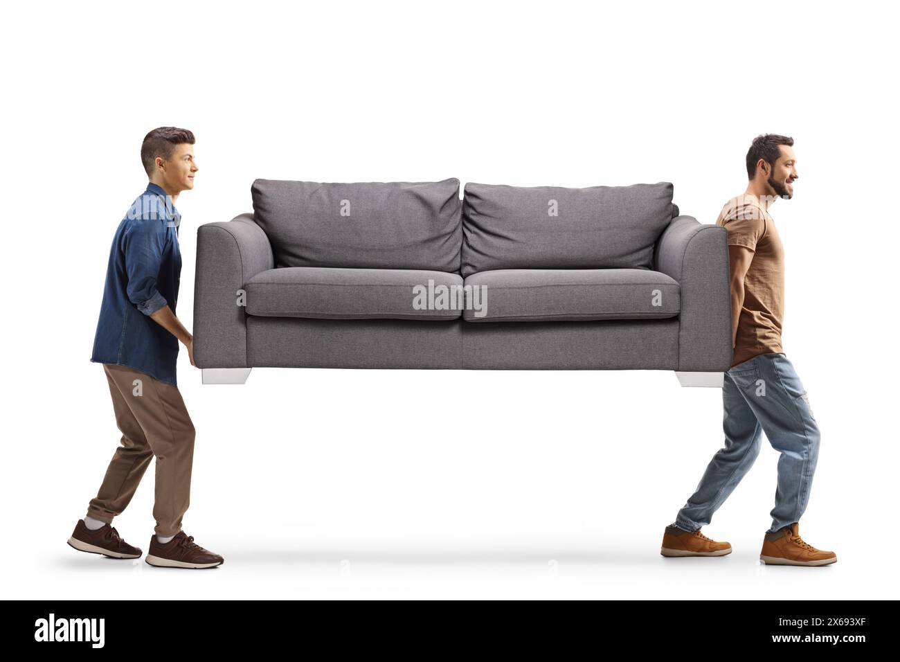 Young men moving a gray sofa isolated on white background Stock Photo ...