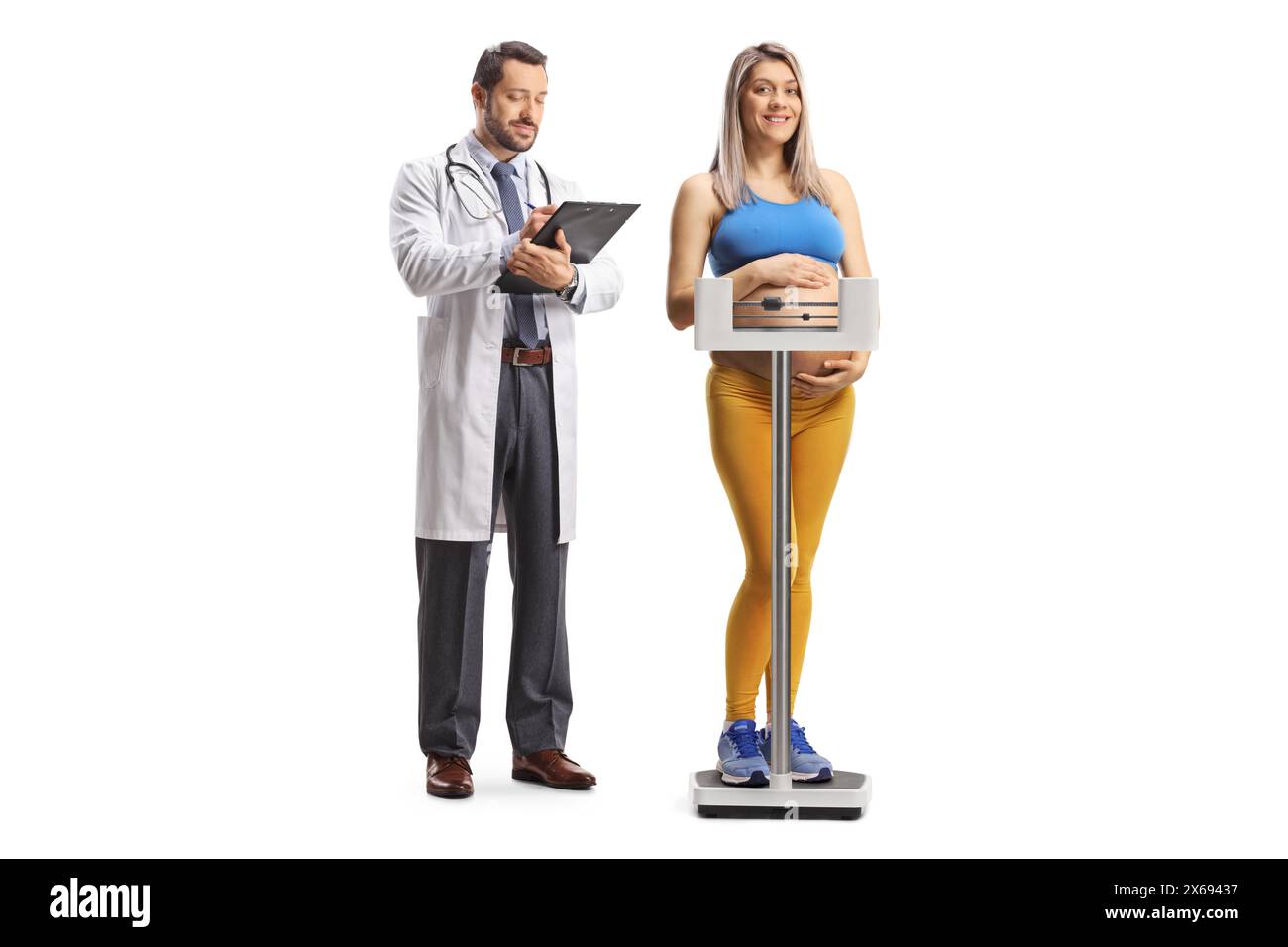Male doctor checking weight of a pregnant woman on a medical scale ...