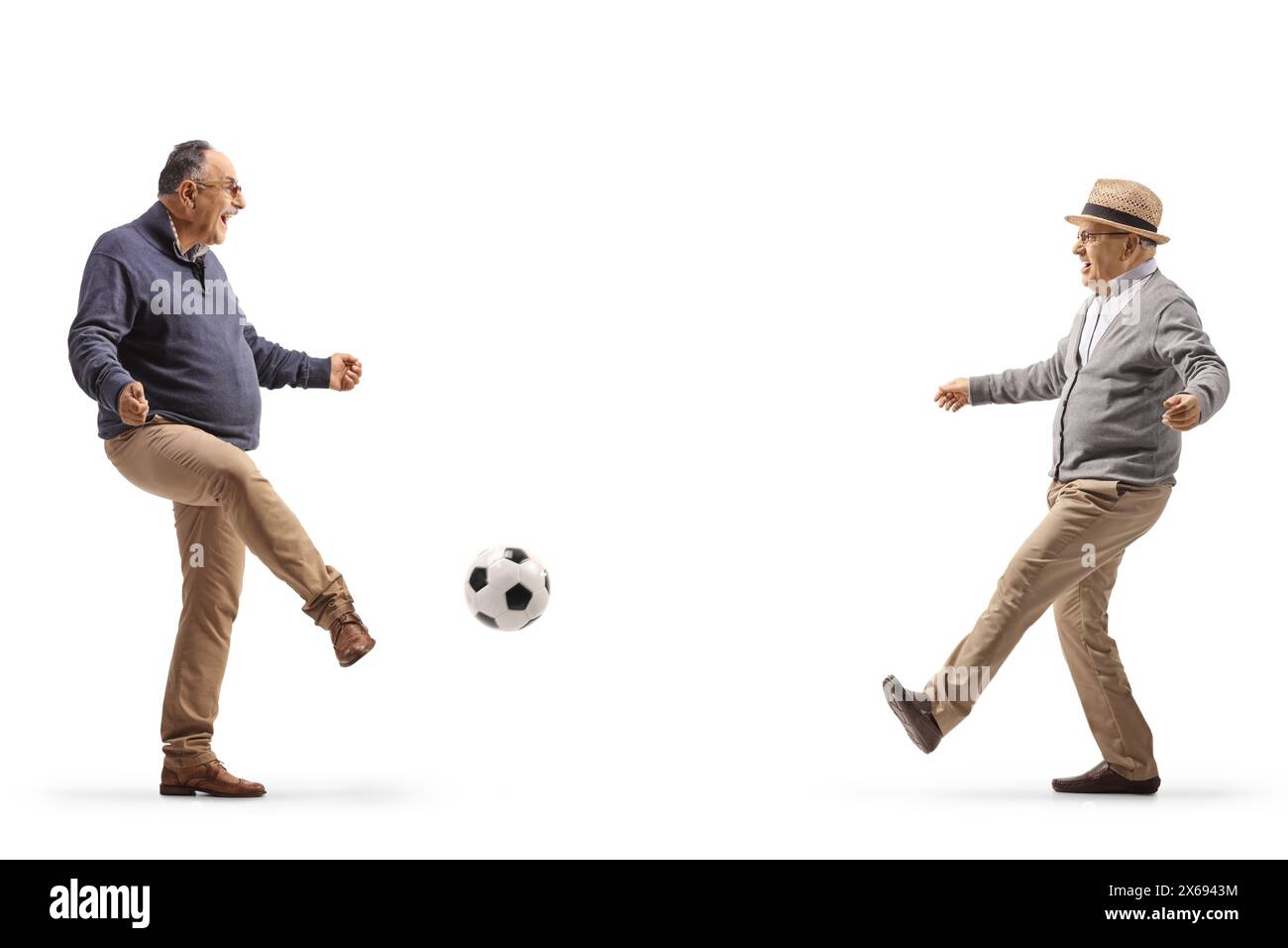 Two mature men kicking football isolated on white background Stock ...