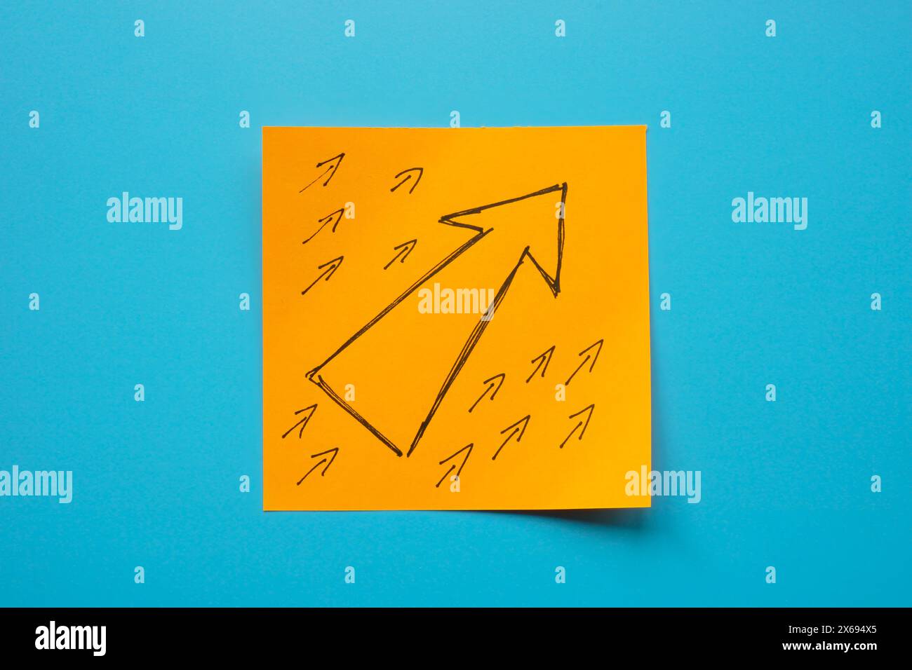 Paper sticker with a large arrow and small ones as a concept of ...