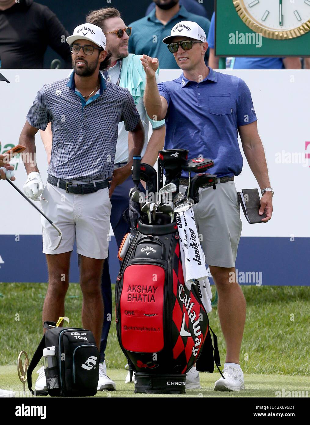Akshay Bhatin (L) talks with his caddie before teeing off on the ...