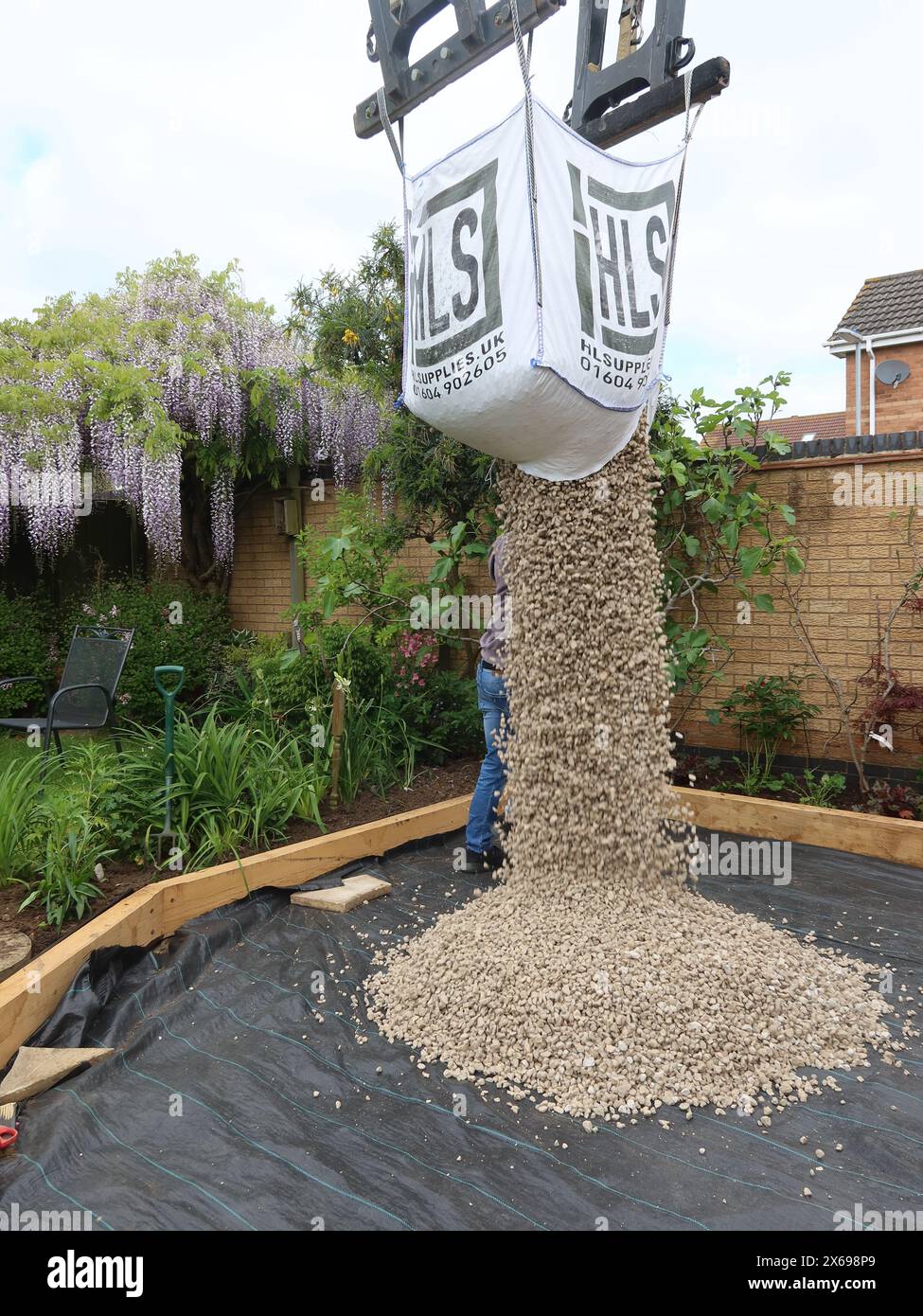 Aggregates for hard landscaping: gravel is delivered to a back garden ...