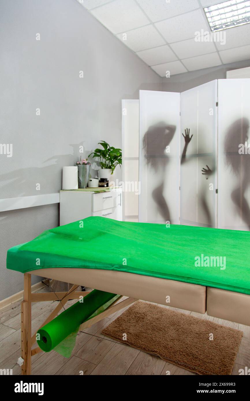 Bright modern massage room interior details, green massage couch table ...