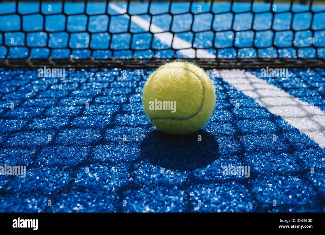paddle tennis ball near the net of a paddle tennis court, sunny day ...