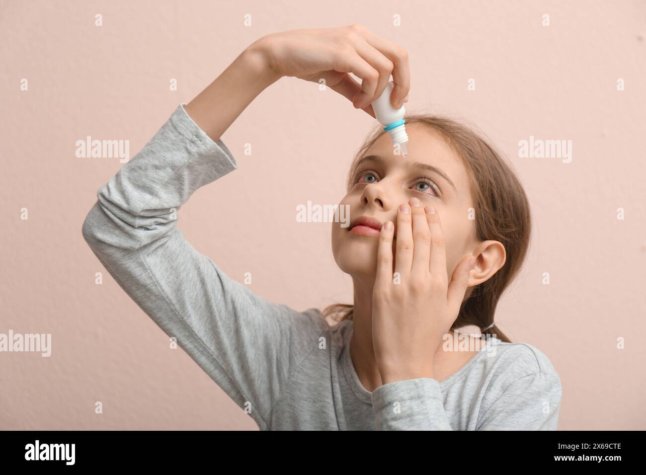 Conjunctivitis. Girl using eye drops on beige background Stock Photo ...