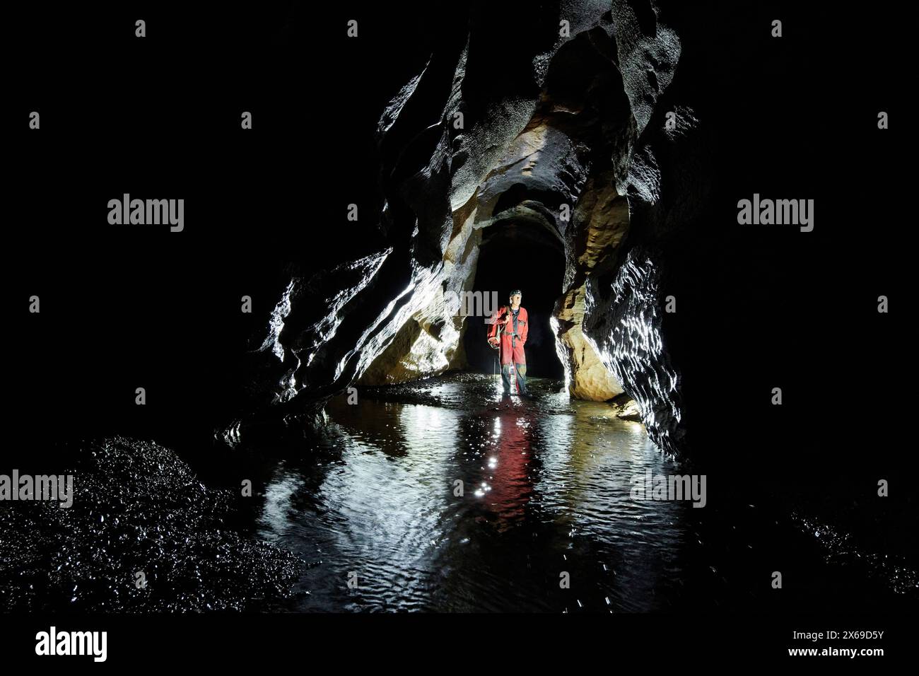 Spelunkers in a cave, black beach Stock Photo - Alamy