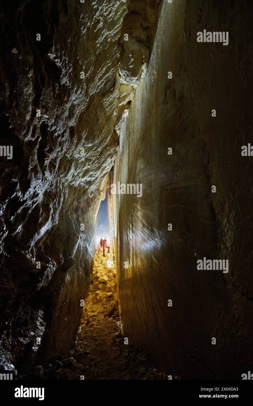 Speleologist in a cave, mirror cave Stock Photo - Alamy