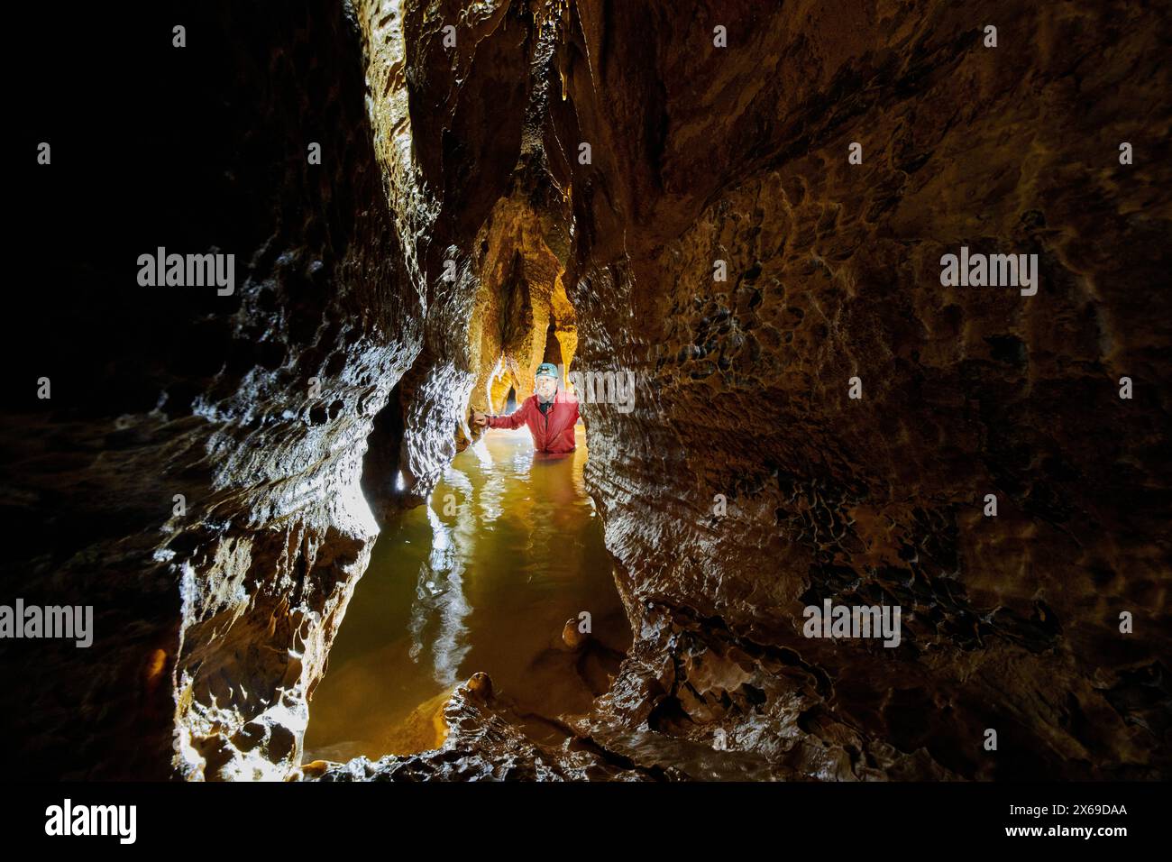 Cave explorers in the water Stock Photo - Alamy