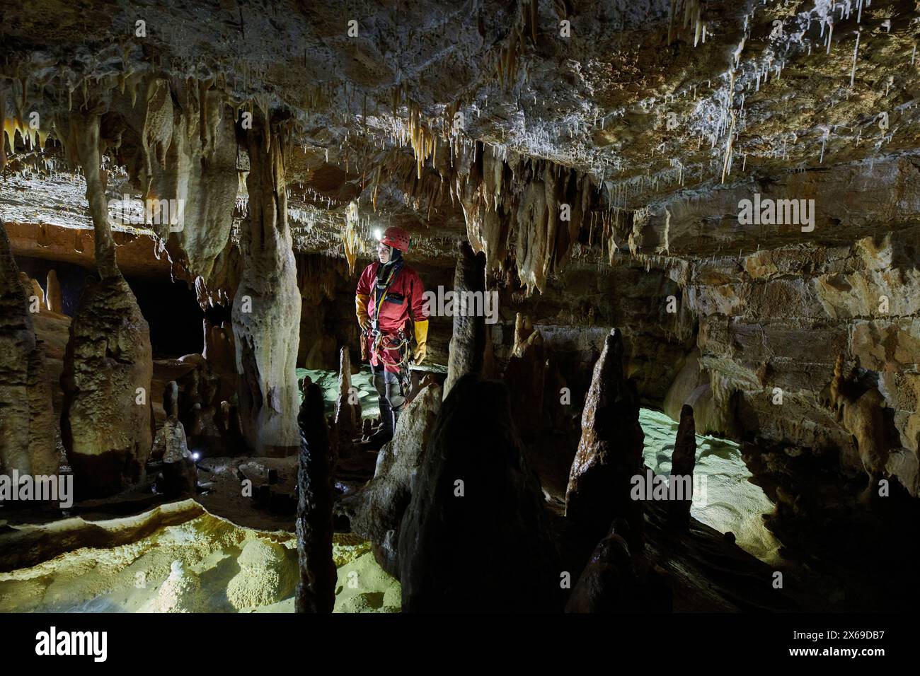 Cave explorers in the forest of stalagmites and stalactites Stock Photo ...