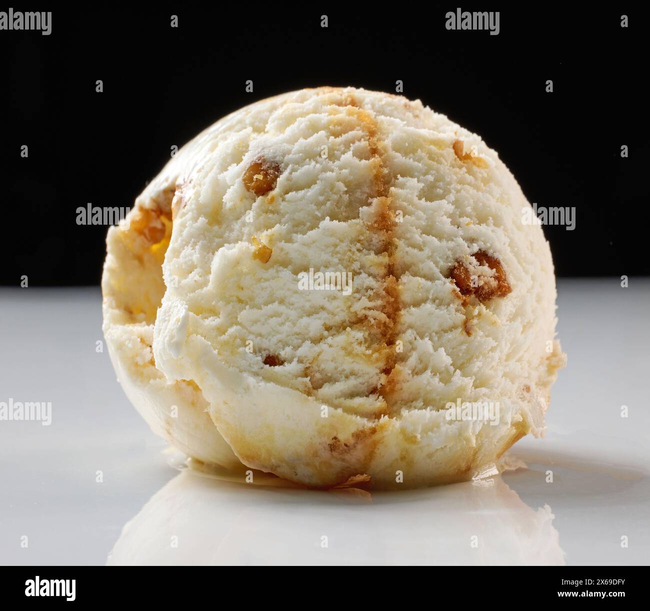 maple syrup and walnut ice cream scoop on black and white background ...