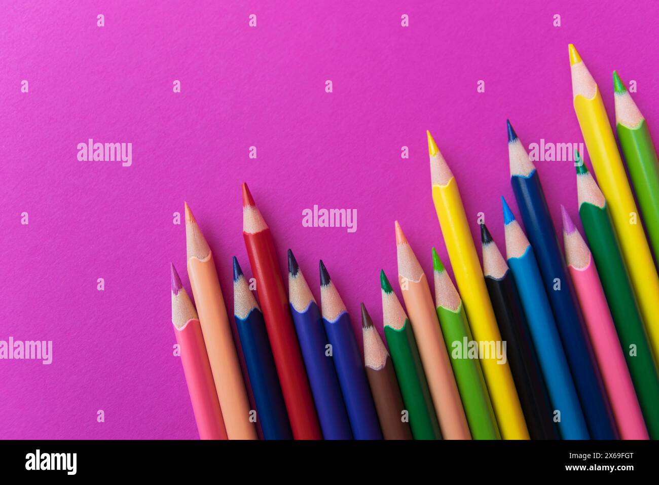 Color pencils on the pink background. Close up. Design concept. Space ...
