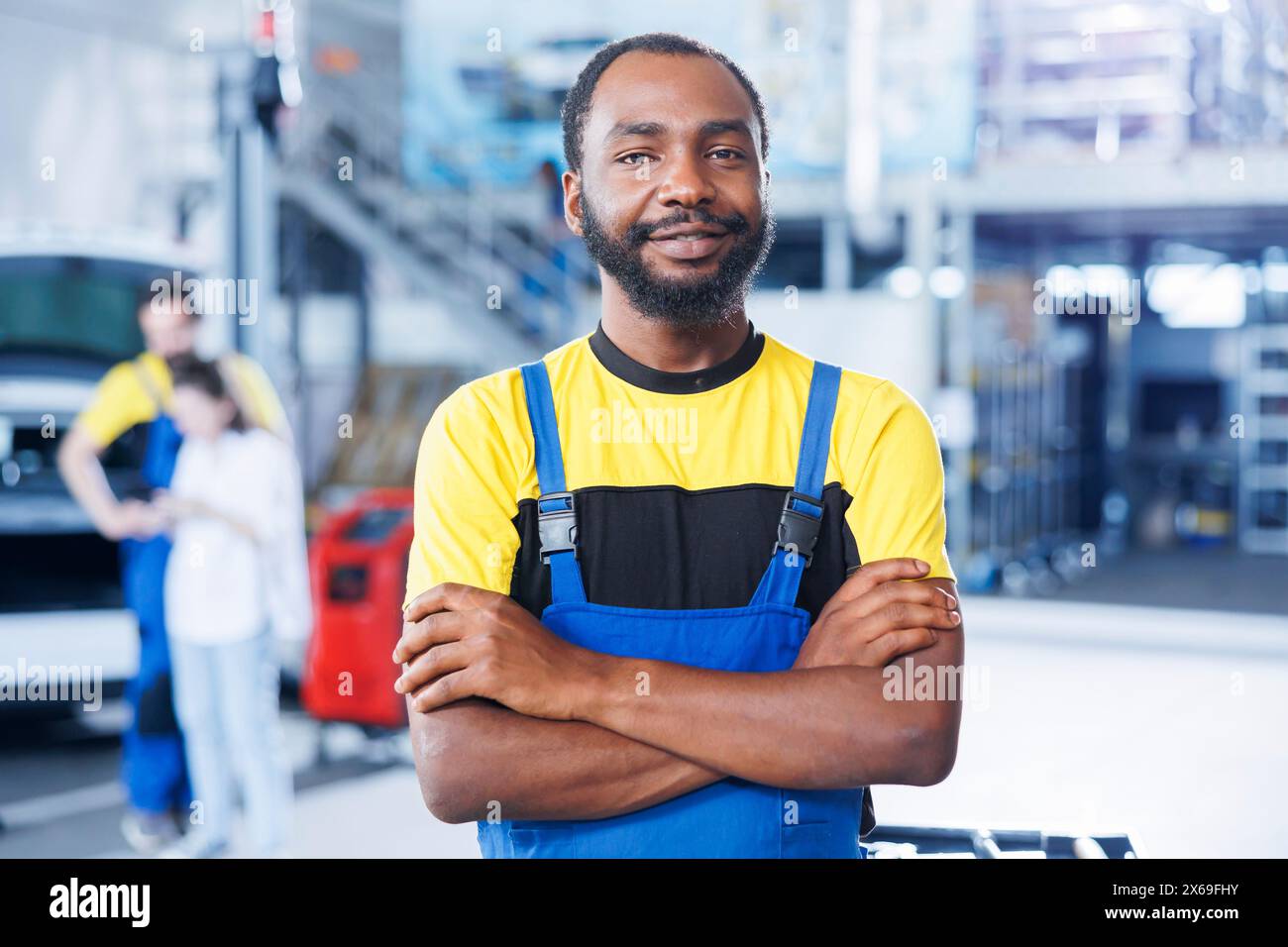 Portrait of smiling BIPOC mechanic in auto repair shop tasked with ...
