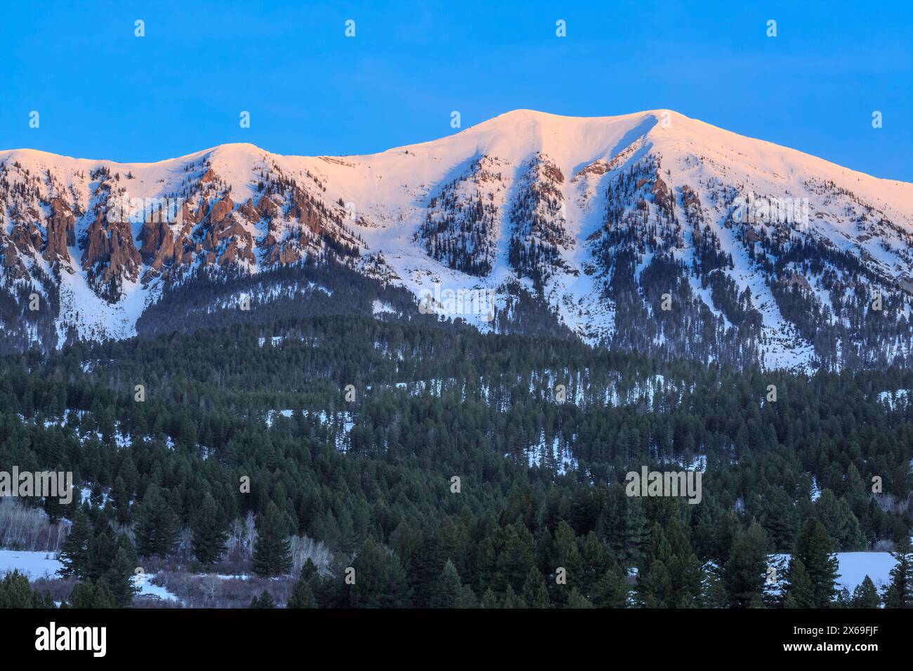 first light on saddle mountain in the bridger range near bozeman ...