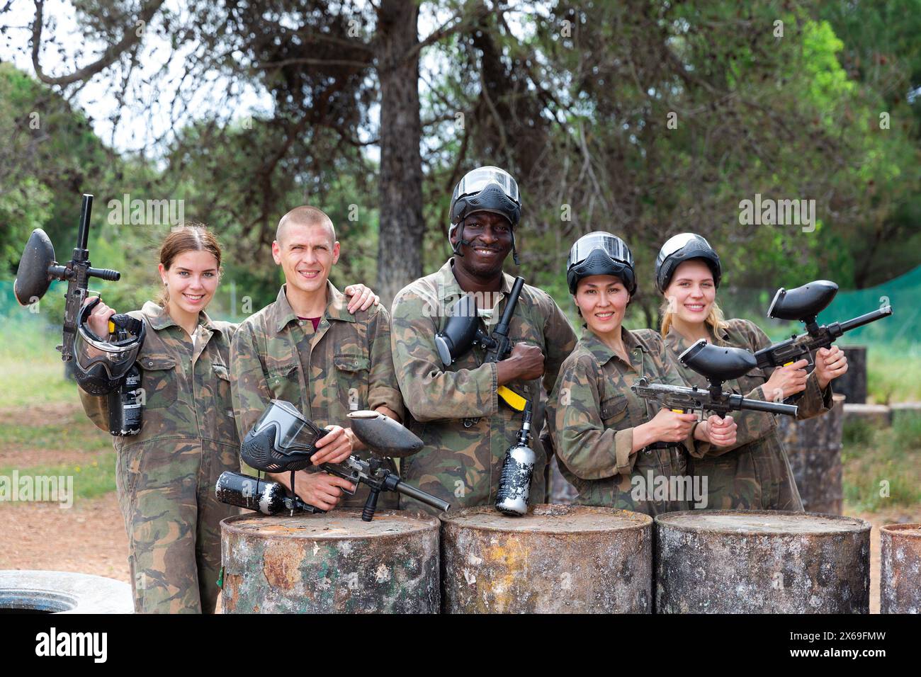 Group portrait of team of paintball players with marker guns Stock ...