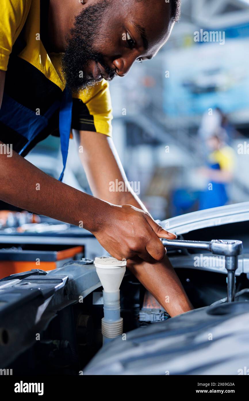 Engineer expertly examines car exhaust pipes using advanced mechanical ...