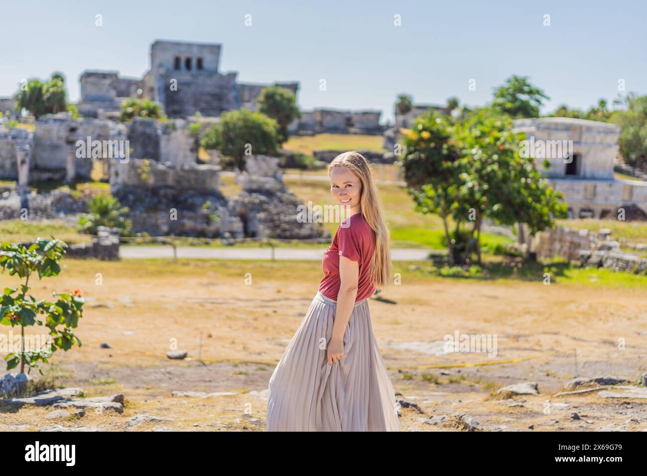 Woman tourist enjoying the view Pre-Columbian Mayan walled city of ...
