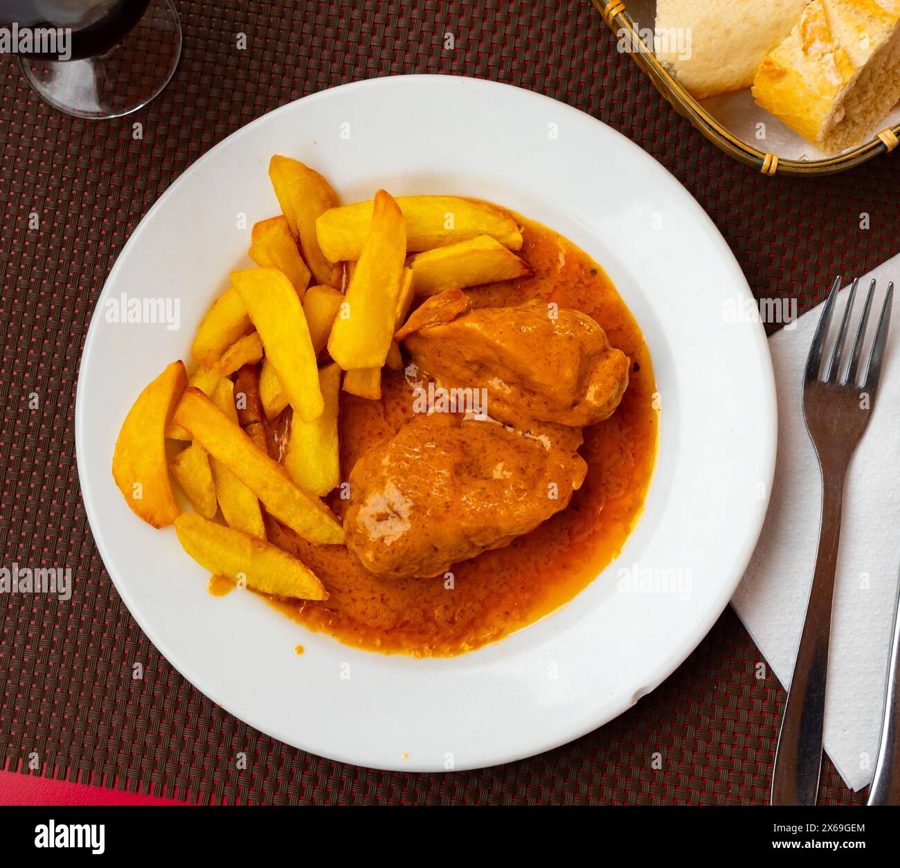 French fries and piece of hot fried chicken stuffed with cheese is ...