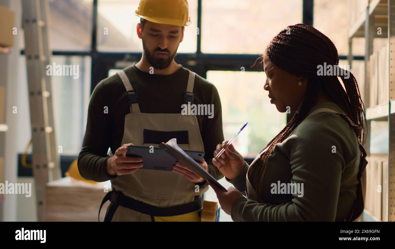 Teamworking colleagues performing warehouse inventory controls, keeping ...
