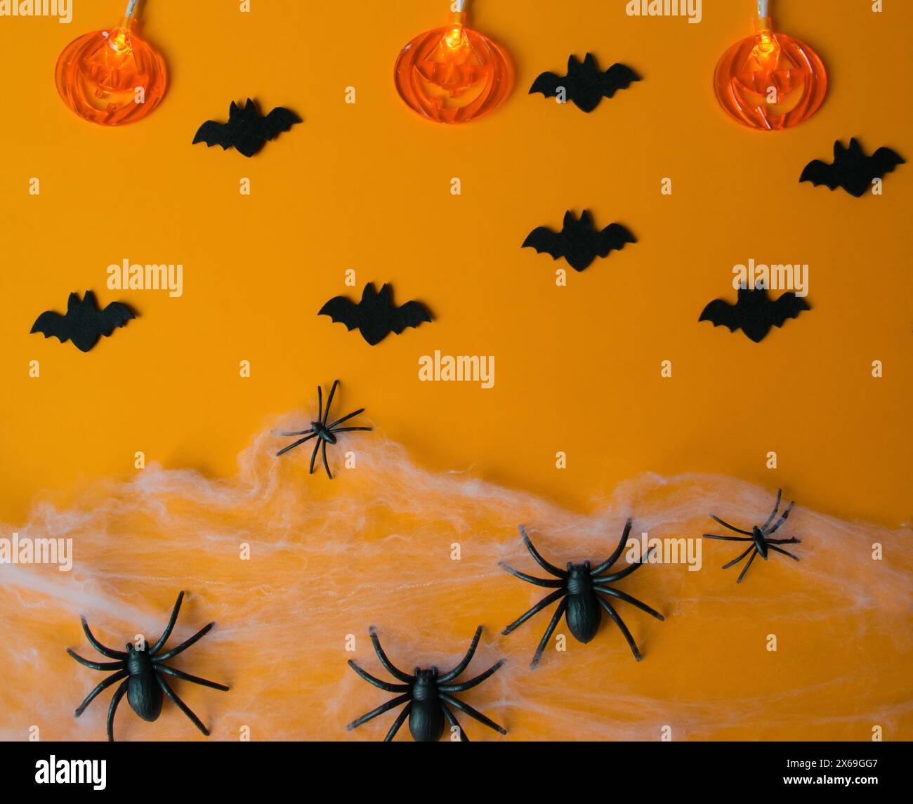 Halloween decorations, pumpkins, bats, web, bugs on orange background ...