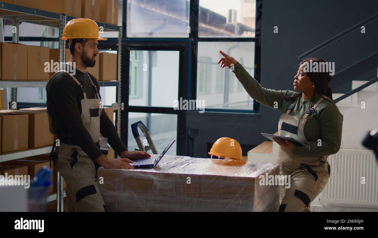 Workers undertaking warehouse inventory evaluation, keeping quality ...