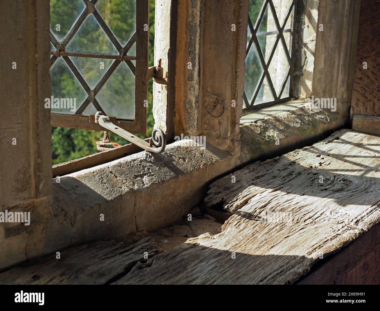 sunlight streaming through open ancient window in historic house with ...