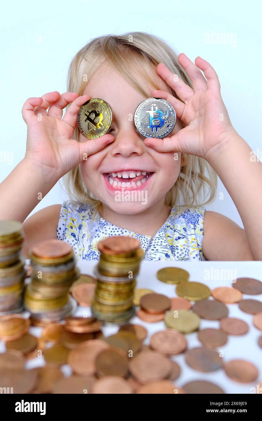 stacks of euro currency coins, small child, blonde girl 3 years old ...