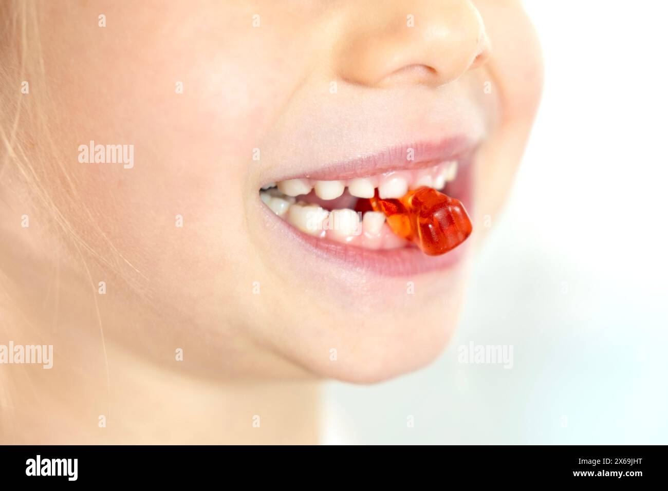 close-up preschool child, girl 5 years old wants eat gelatinous sweets ...