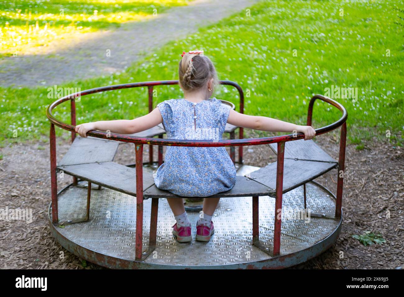 happy preschool girl, child spinning on carousel on summer day ...