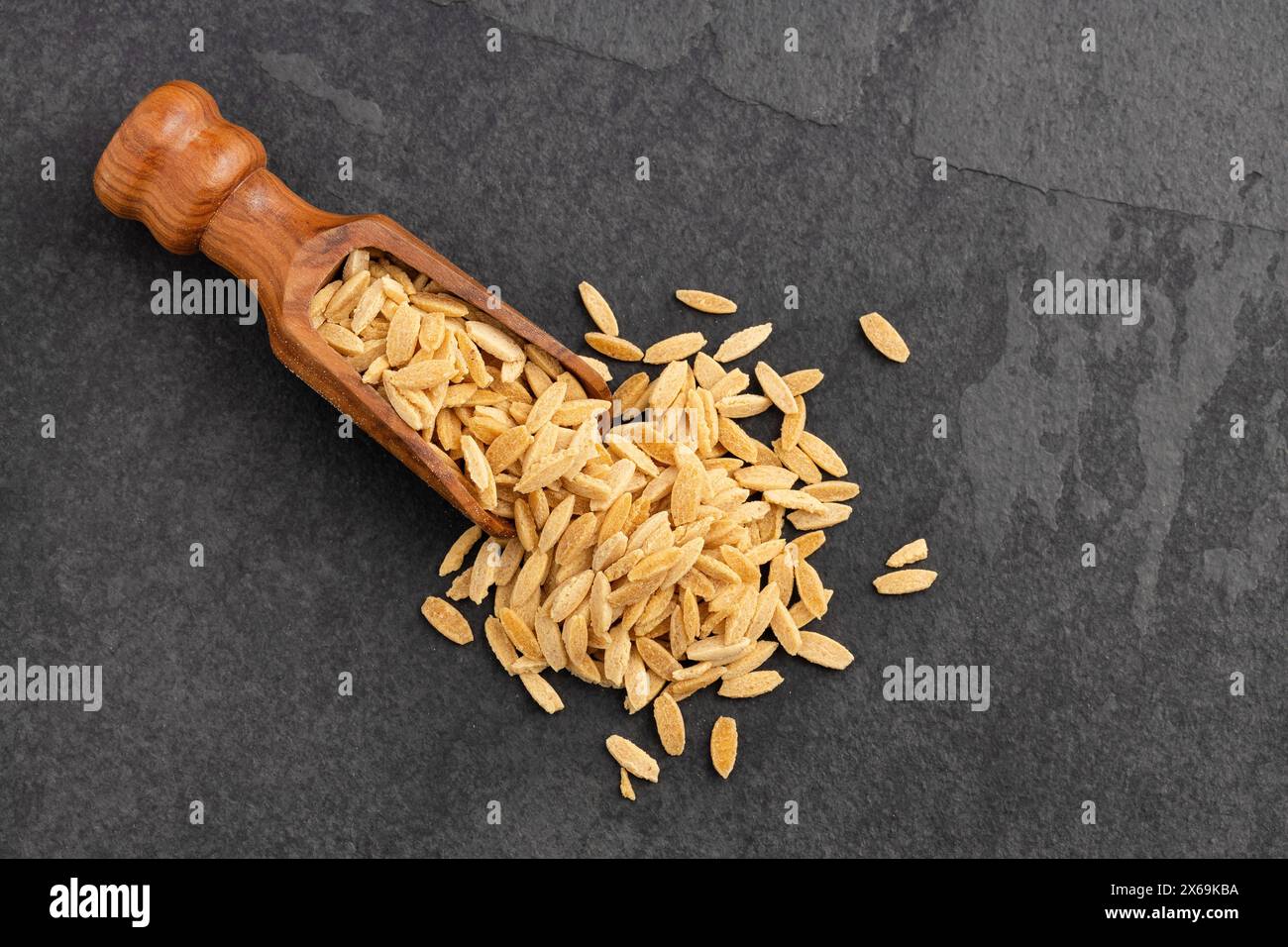Risoni, uncooked pasta - Organic dried orzo on the spoon Stock Photo ...