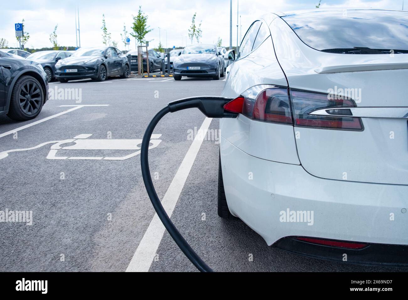Tesla model y electric car on Free charging station, Tesla-Supercharger ...