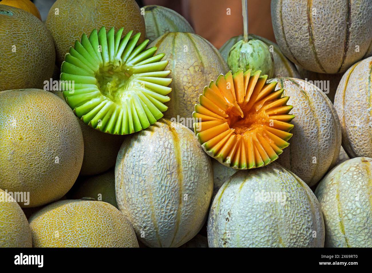 Open cut carved melon fruit sold outside on market stall Stock Photo ...