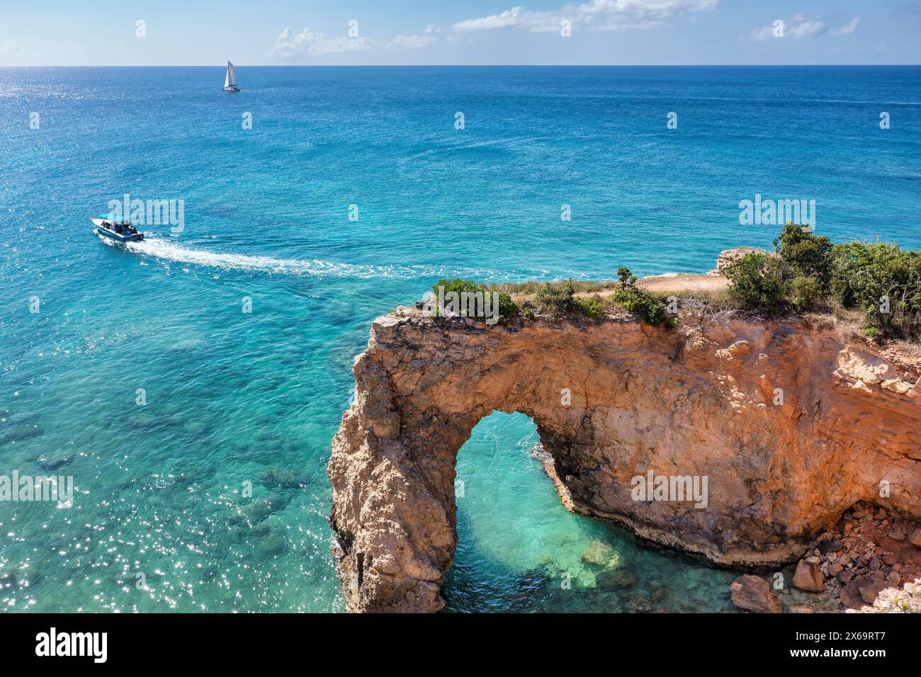 Aerial view of the Anguilla Arch with a tourist boat and sailboat ...