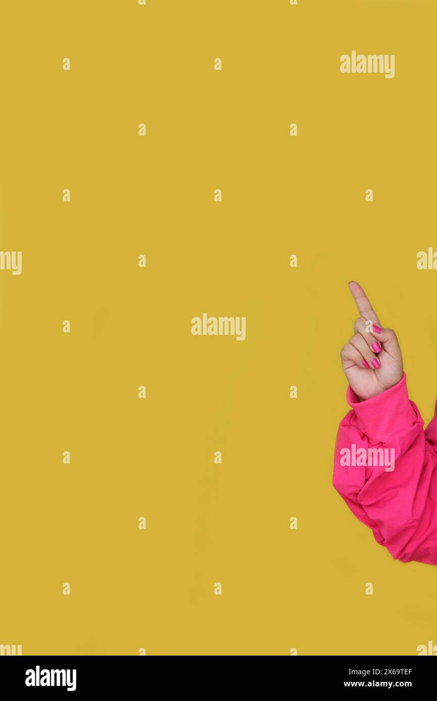 Latina 30 year old woman points finger at copy space for promotions and ...