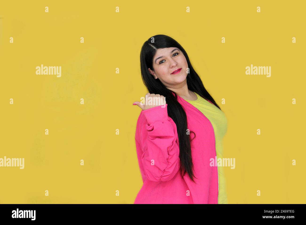 Latina 30 year old woman points finger at copy space for promotions and ...