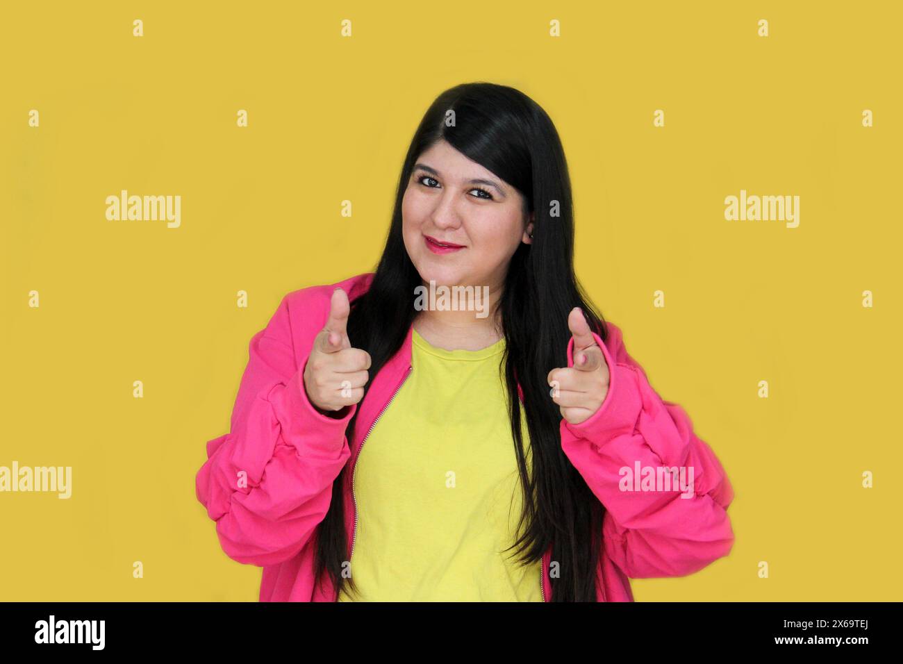 Latina 30 year old woman points finger at copy space for promotions and ...