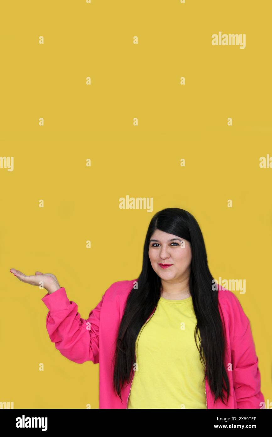 Latina 30 year old woman points finger at copy space for promotions and ...