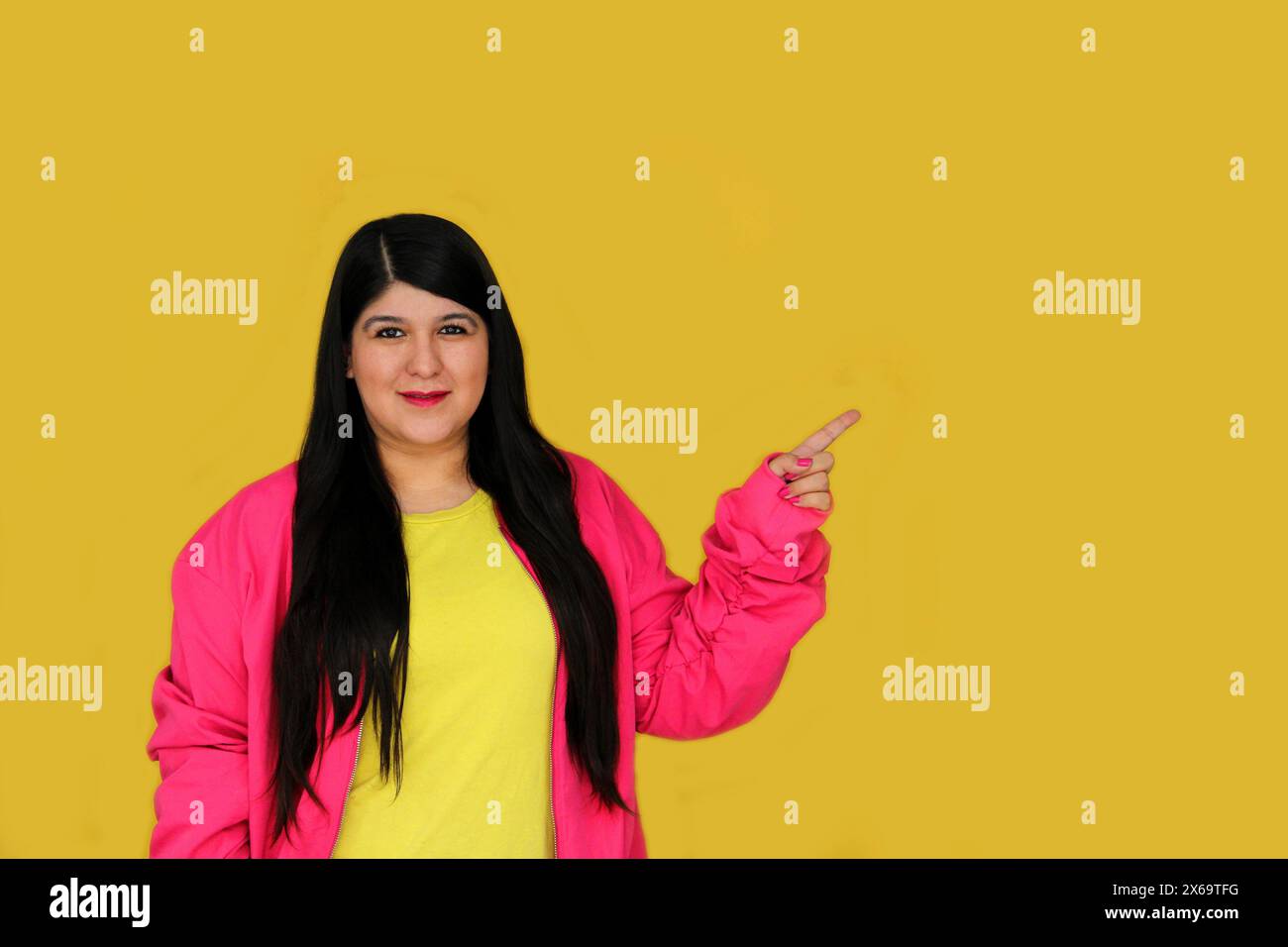 Latina 30 year old woman points finger at copy space for promotions and ...