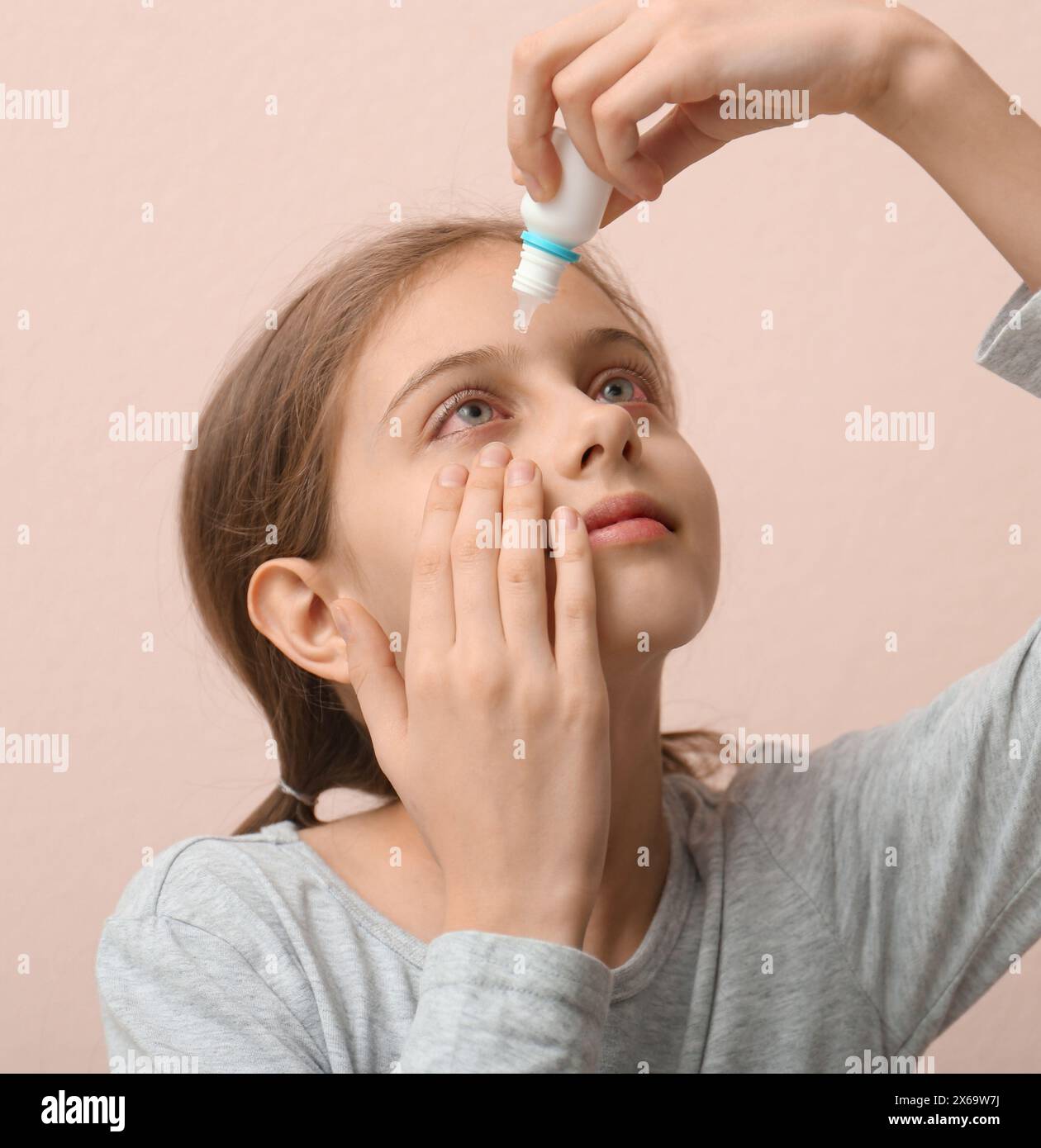 Conjunctivitis. Girl using eye drops on beige background Stock Photo ...