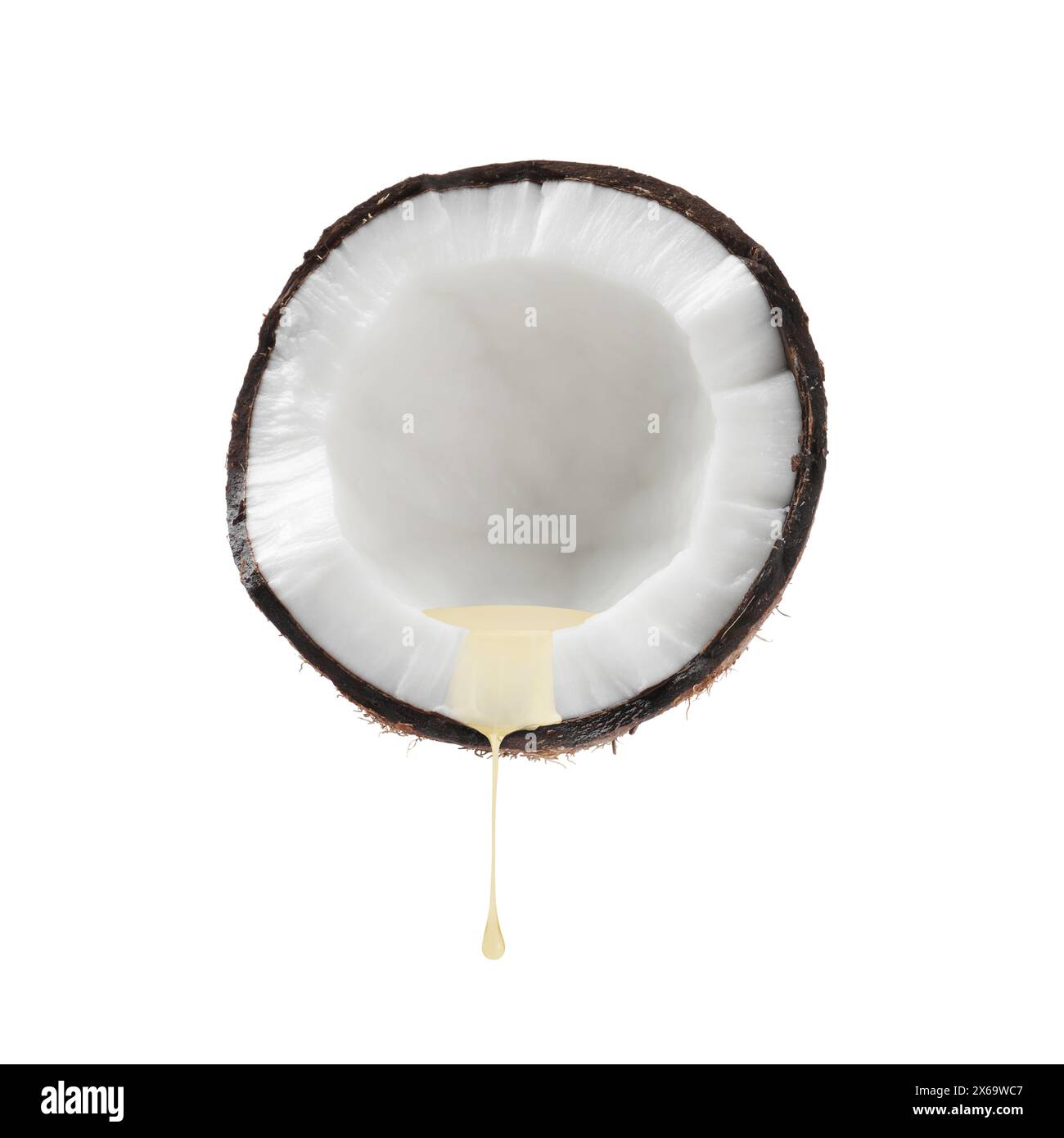 Coconut with dripping oil isolated on white Stock Photo - Alamy