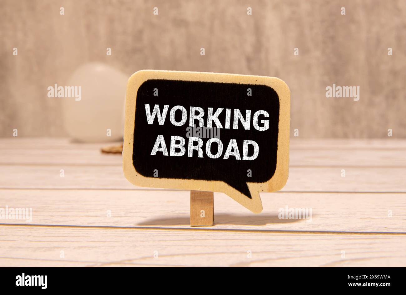 working abroad. text on wooden blocks on a blue background. business ...