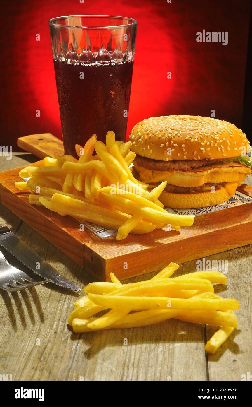 Hamburger with chips and coca cola drink over red gradient Stock Photo ...