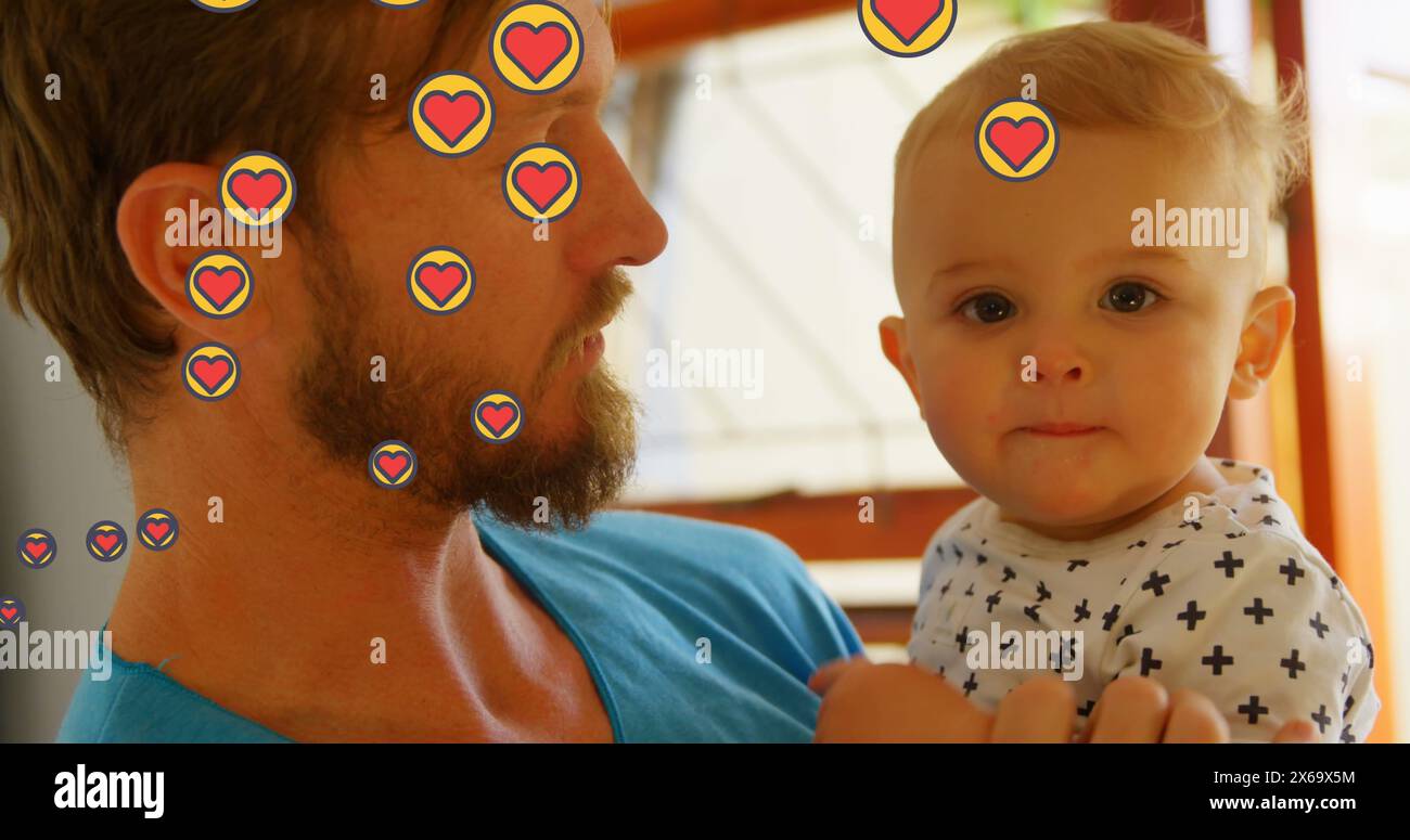 Image of heart icons over caucasian father with baby Stock Photo - Alamy