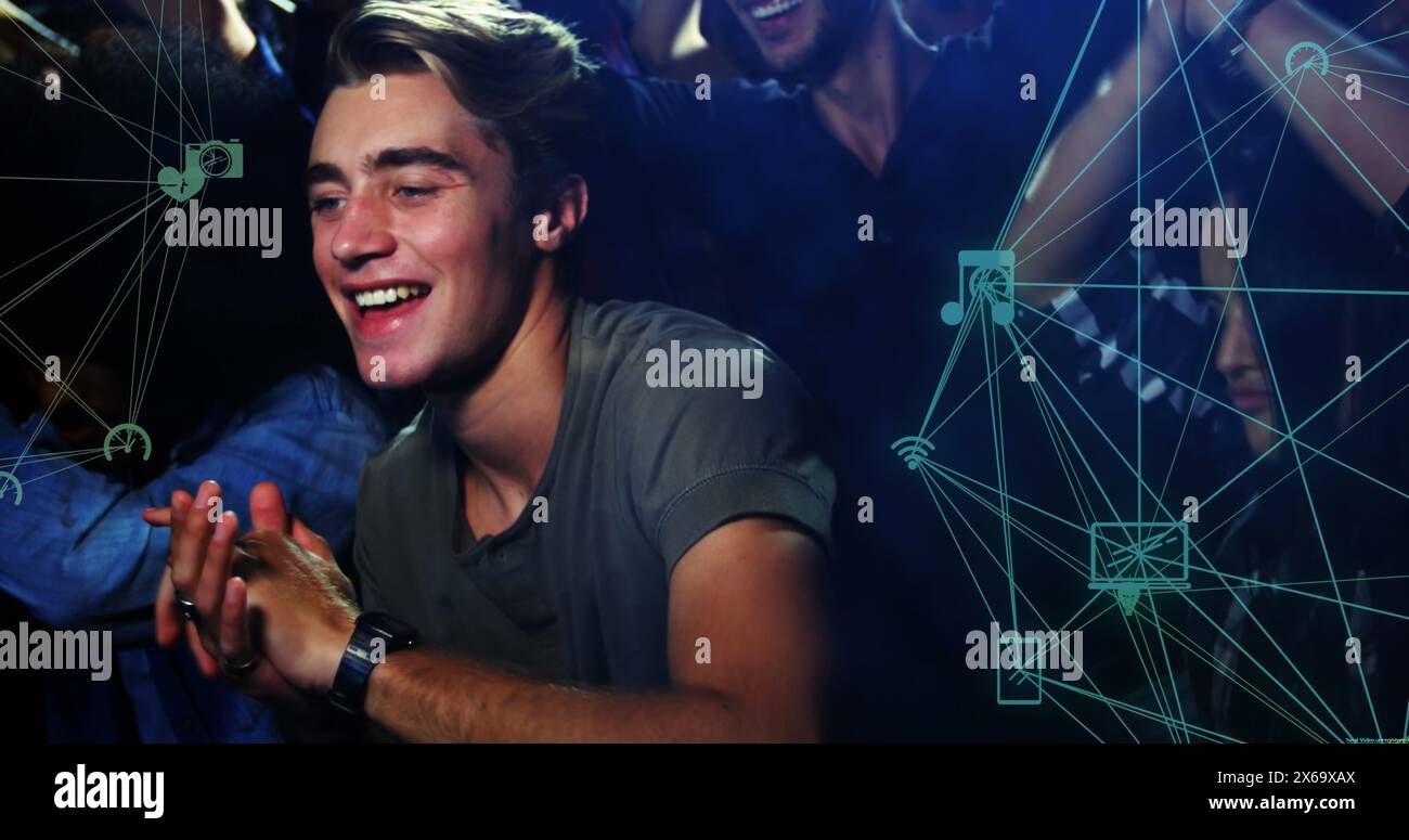 Image of connections with icons over happy caucasian man having fun on ...