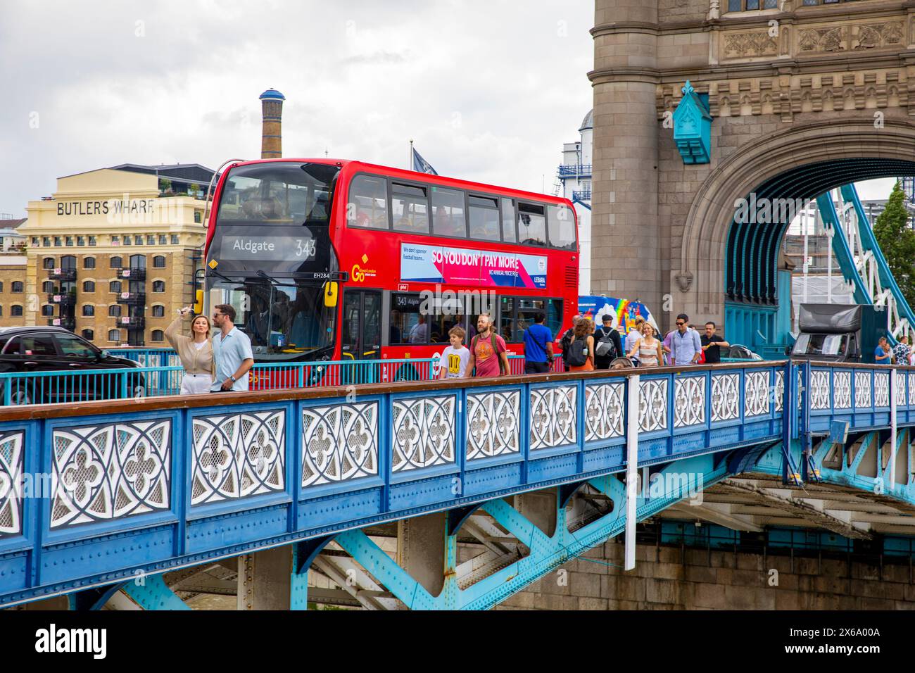 Tower Bridge London famous landmark, walkers tourists cross the bridge beside London double ...