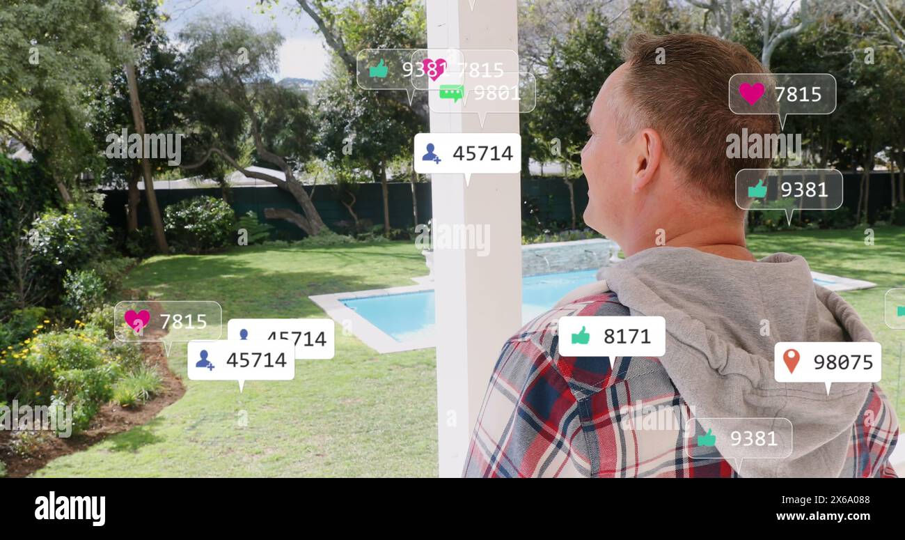 Caucasian grandfather looking at floating social media icons in garden ... Caucasian grandfather looking at floating social media icons in garden ...