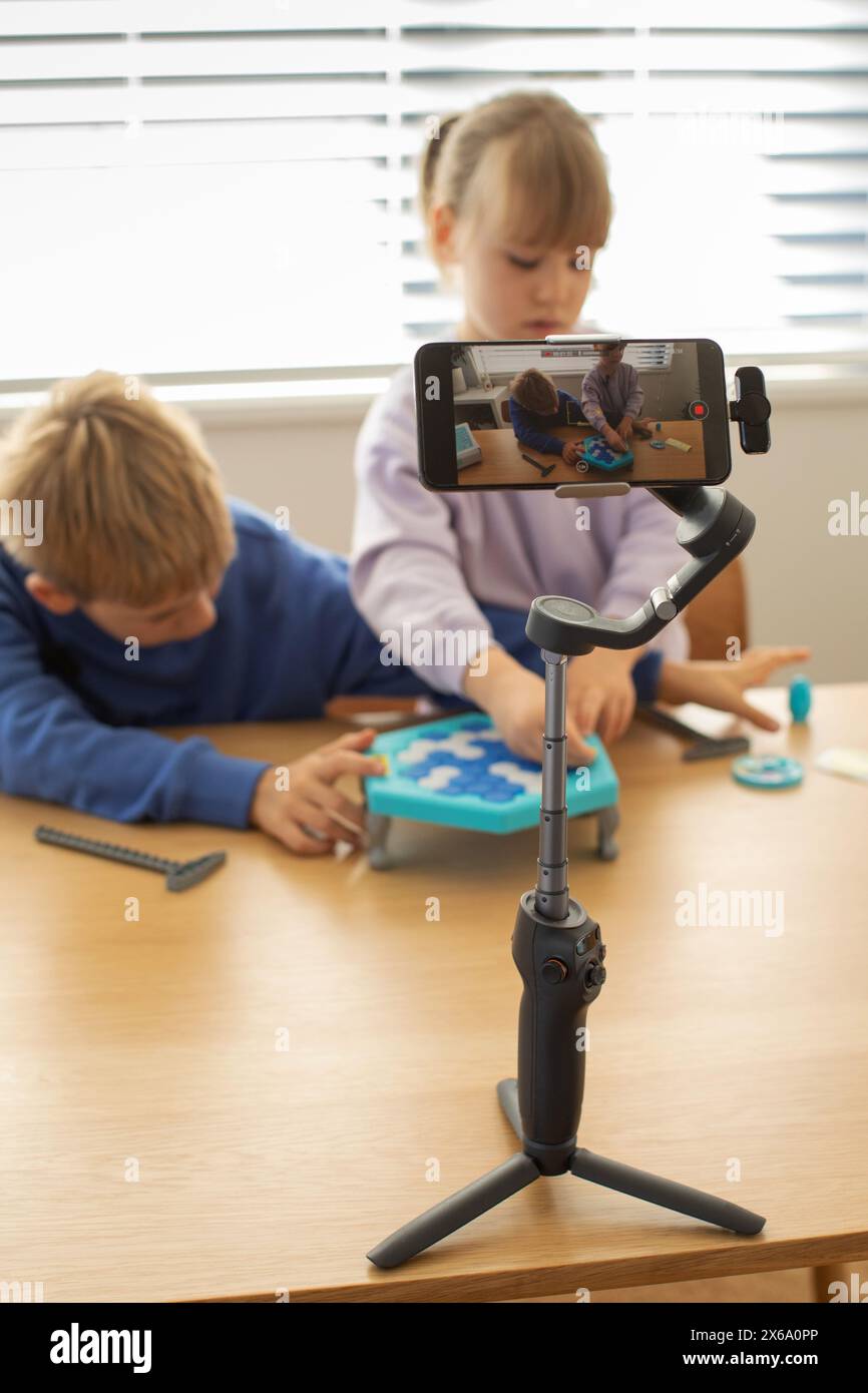 Kids play a new board game for their blog, recording a fun and ...