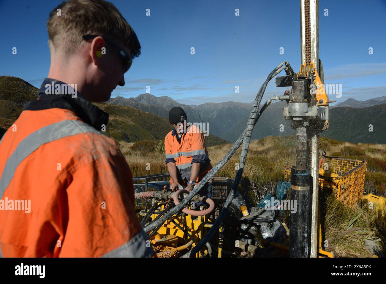 HAUPIRI, NEW ZEALAND, MAY 7, 2024: Drillers operate a portable drilling ...