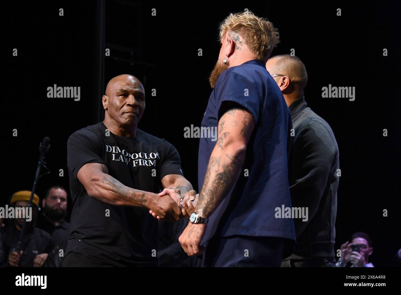 (L-R) Mike Tyson and Jake Paul shake hands onstage at the Apollo ...