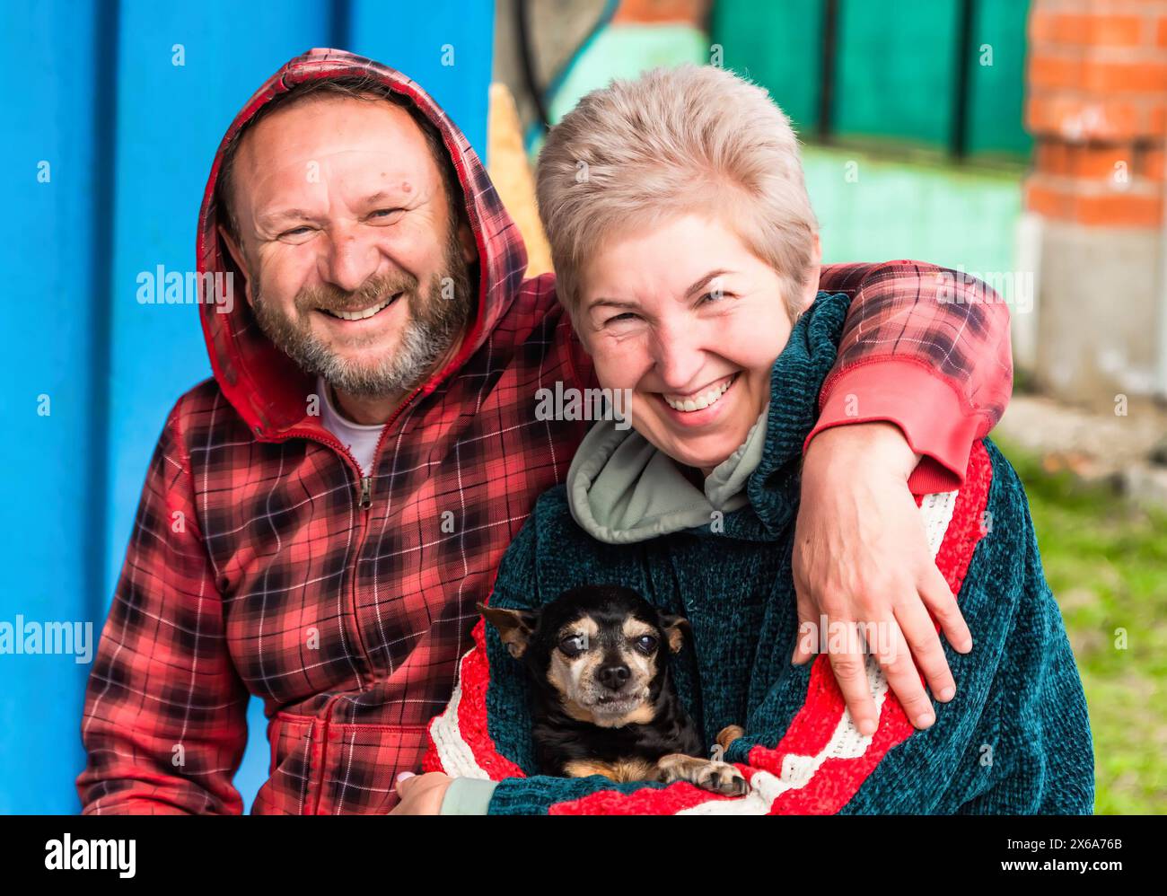 Mature russian married couple hugging and holding a dog Stock Photo - Alamy