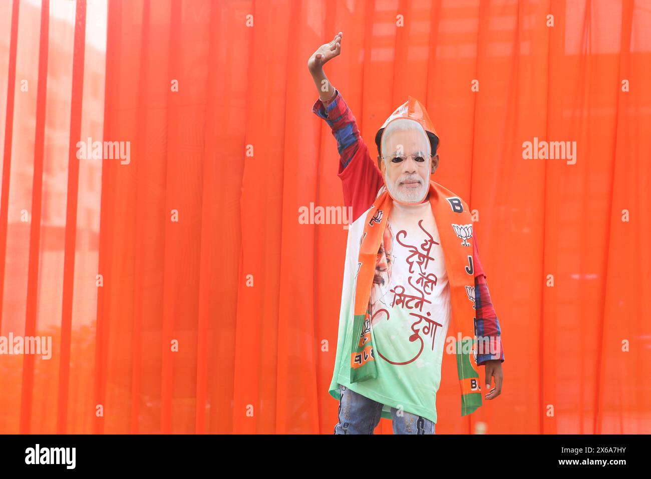 Varanasi, India. 13th May, 2024. A kid wearing the face cutout of India ...